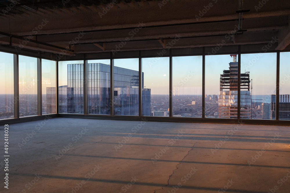 Two high-rise buildings visible through floor to ceiling windows of ...