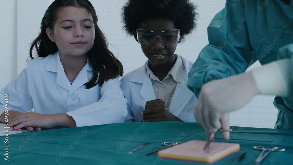 Education concept. Medical school students practicing suturing wounds ...