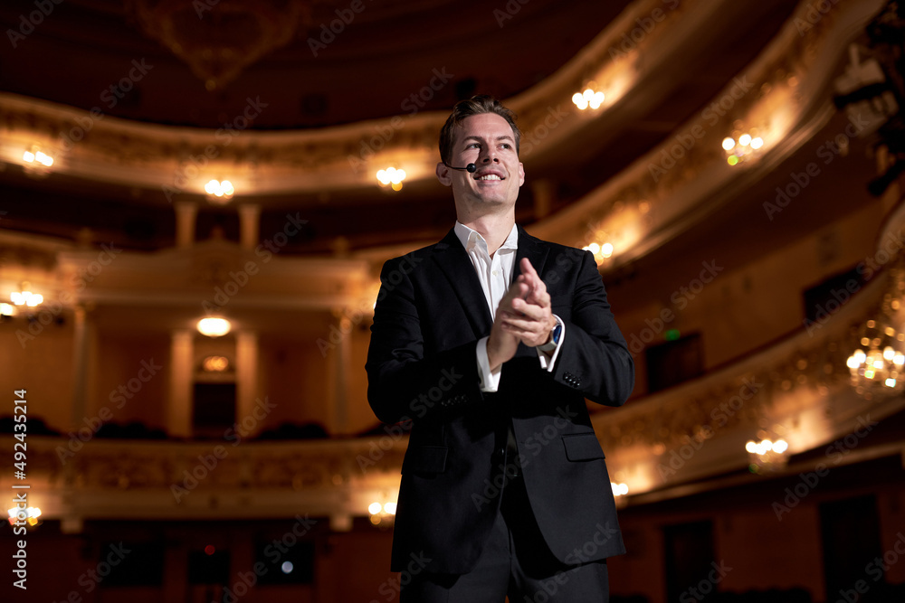 Confident guy of american appearance in formal classic suit clapping ...