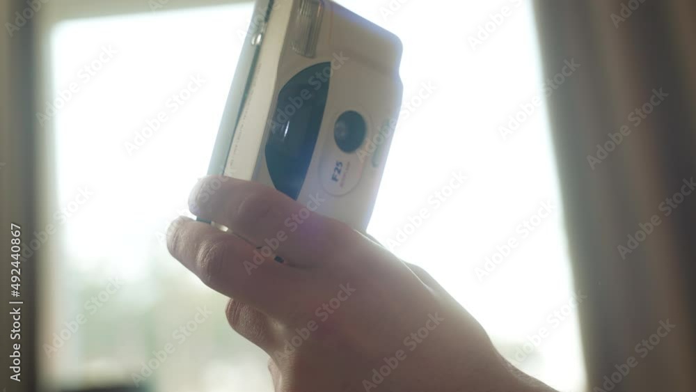 Hand holding early 2000s vintage retro hipster camera analogue analog ...