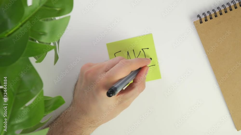 Fake text on paper. Top view write with a pen on a sticker. Put a ...