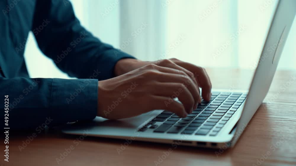 Businessman hand work on capable laptop computer at office table close ...