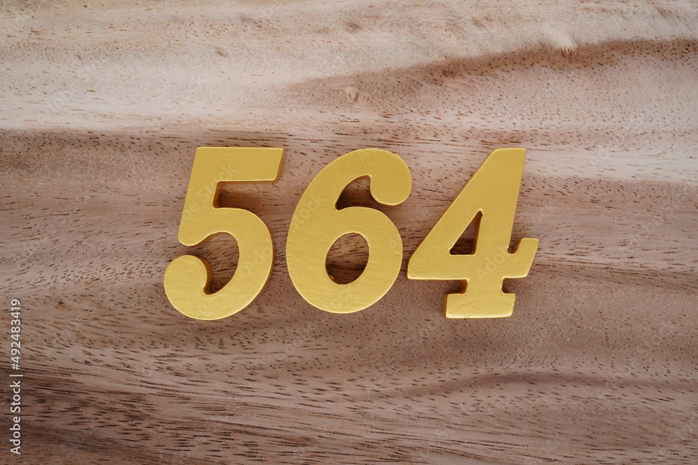 Foto de Golden Arabic numerals on a real brown and white wooden floor ...