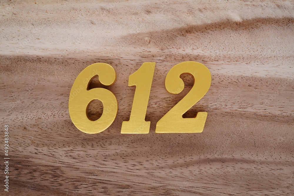 Golden Arabic numerals on a real brown and white wooden floor number ...