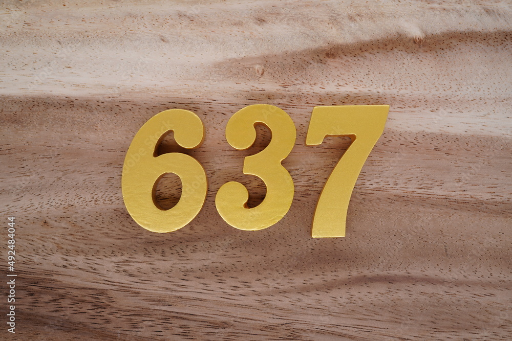 Golden Arabic numerals on a real brown and white wooden floor number ...