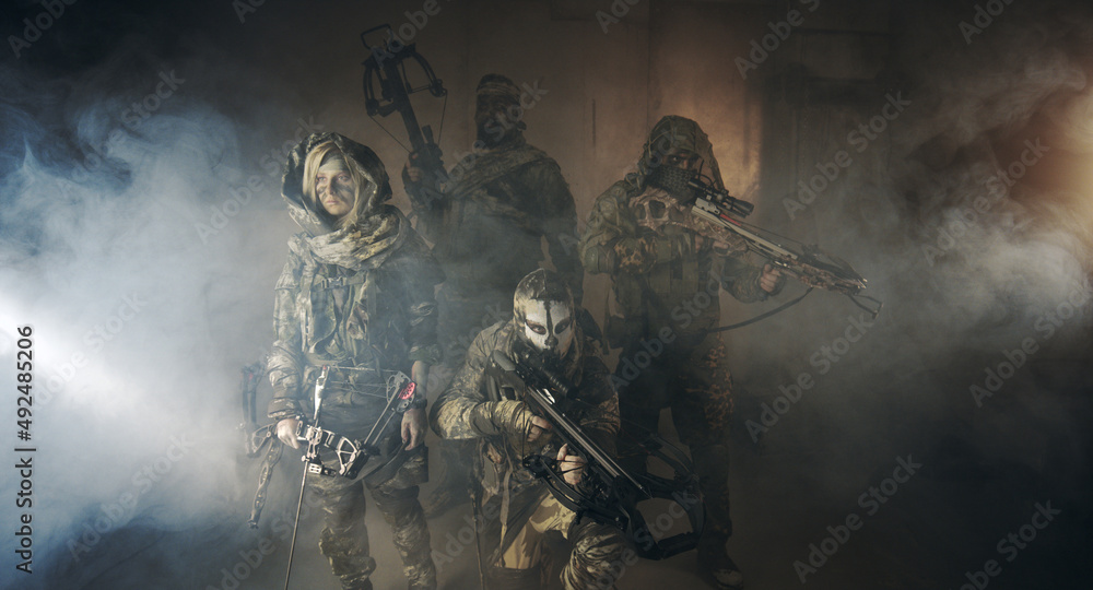 apocalypse fighters. a girl with a bow and a guy with crossbows. Stock ...