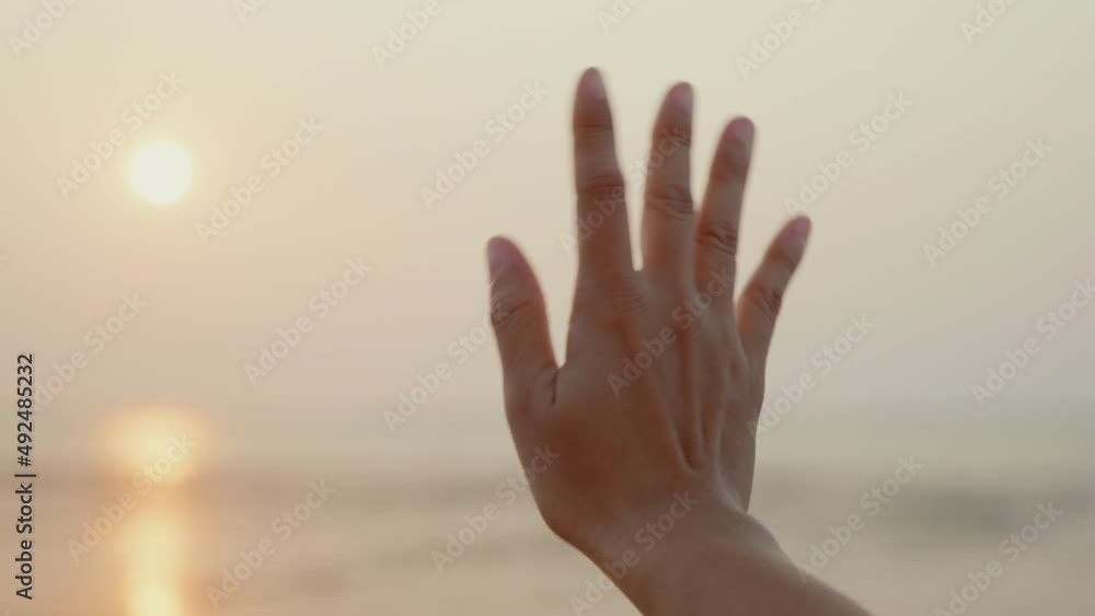 Woman waving hand say goodbye or parting with sunset alone on the ...