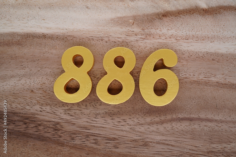 Golden Arabic numerals on a real brown and white wooden floor number ...