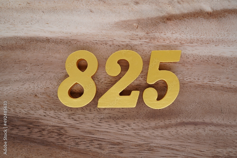 Golden Arabic numerals on a real brown and white wooden floor number ...