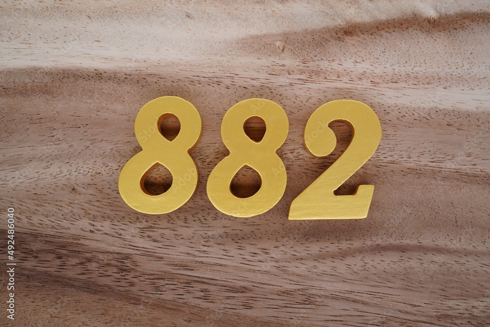 Golden Arabic numerals on a real brown and white wooden floor number ...
