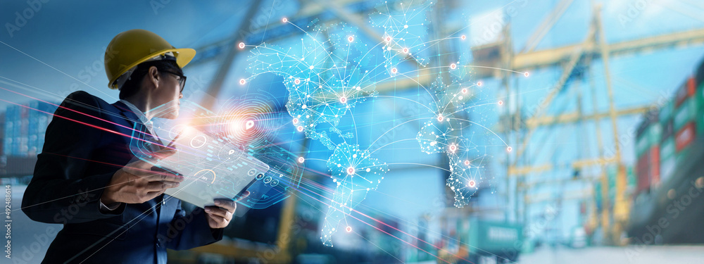 Businessman holding virtual interface panel of global logistics network ...