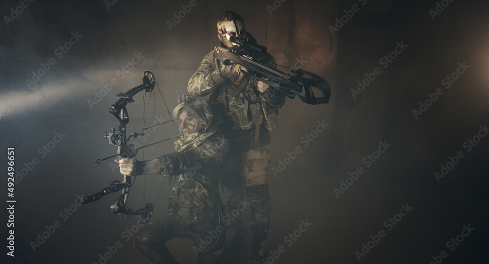 apocalypse fighters. a girl with a bow and a guy with a crossbow. Stock ...