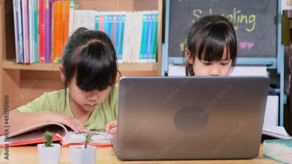 Two Asian female students study online video call Zoom with laptop at ...
