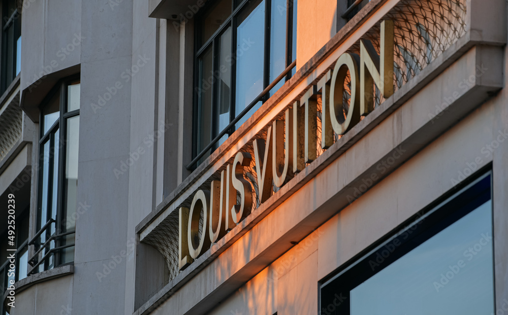 Logo of Louis Vuitton luxury clothing company on top of a store from ...