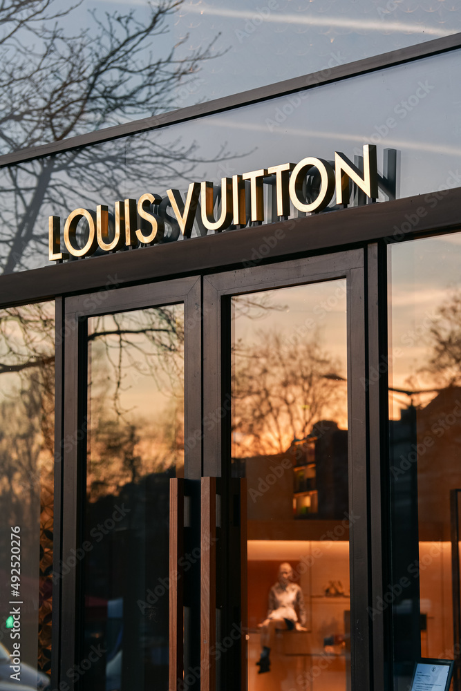 Logo of Louis Vuitton luxury clothing company on top of a store from ...