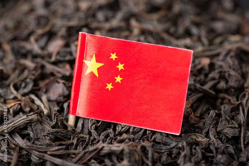 Flag of China on dried black tea. Concept of tea business in China ...