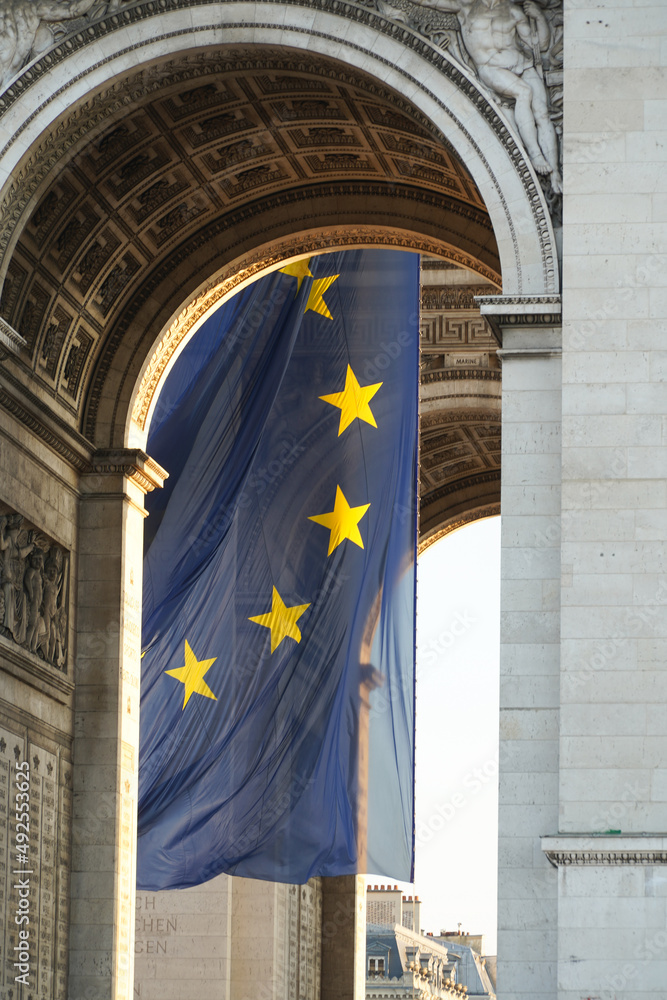 Flag of the European Union winding under the landmark Arch of Triumph ...