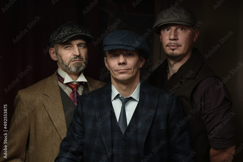 Three men of different ages, an English retro gangster of the 1920s ...