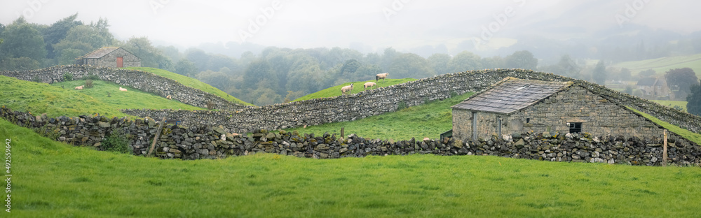 Wide panorama rural English countryside view of old stone walls, barns ...
