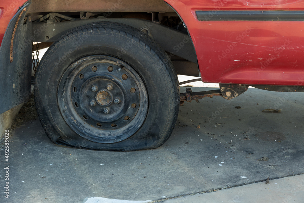 Destroyed blown out tire with exploded, shredded and damaged tire on a ...