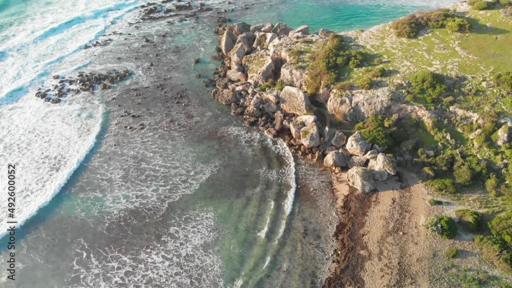 Waves break on the rocks and sands of the beach at Kish Island, Iran ...