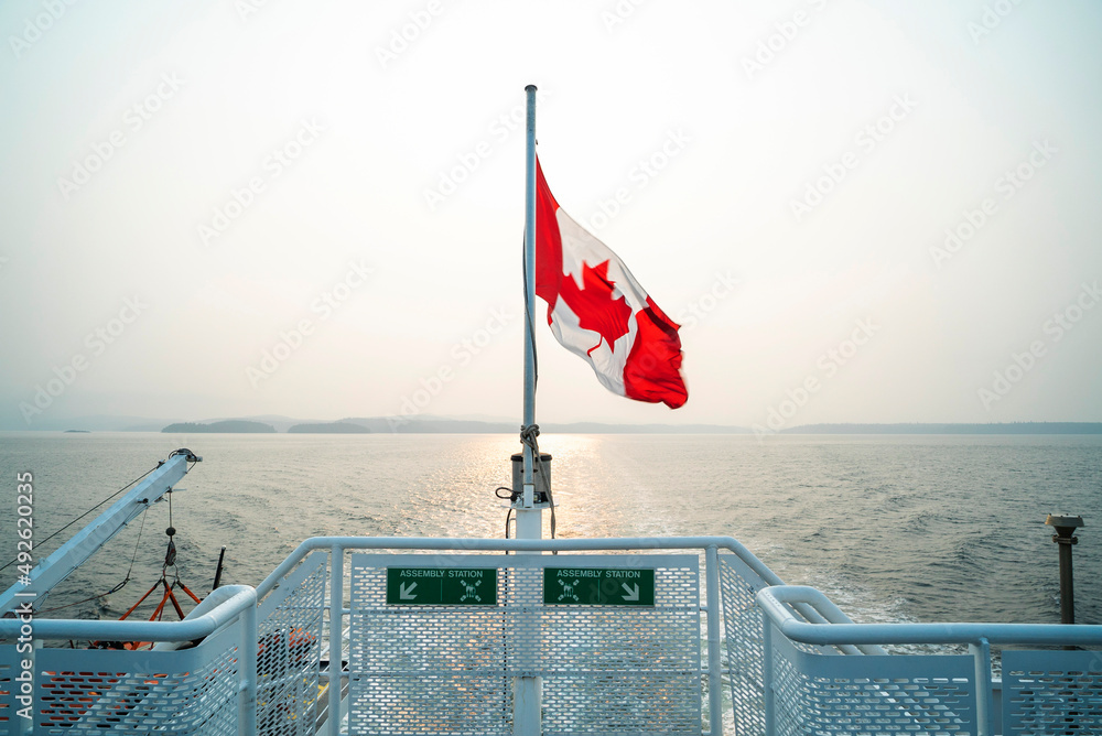 Canadian flag waves at stern of ferry boat over water Stock Photo ...