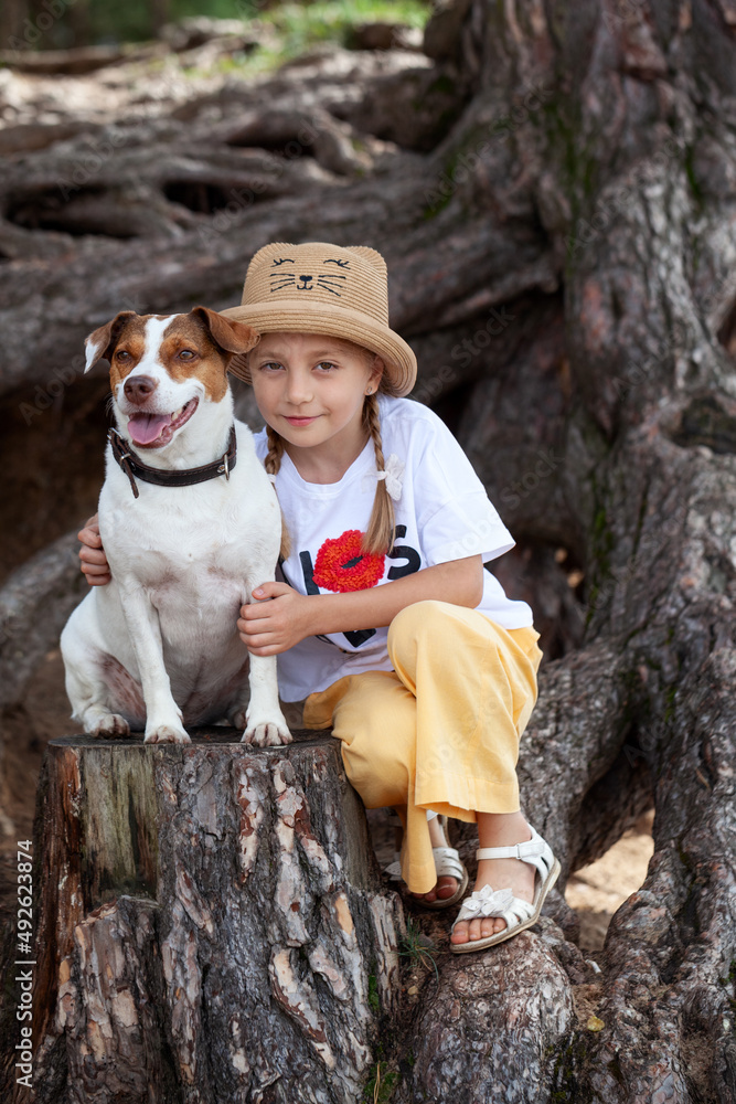 Handsome caucasian happy smiling little gen z girl hugging Jack Russell ...