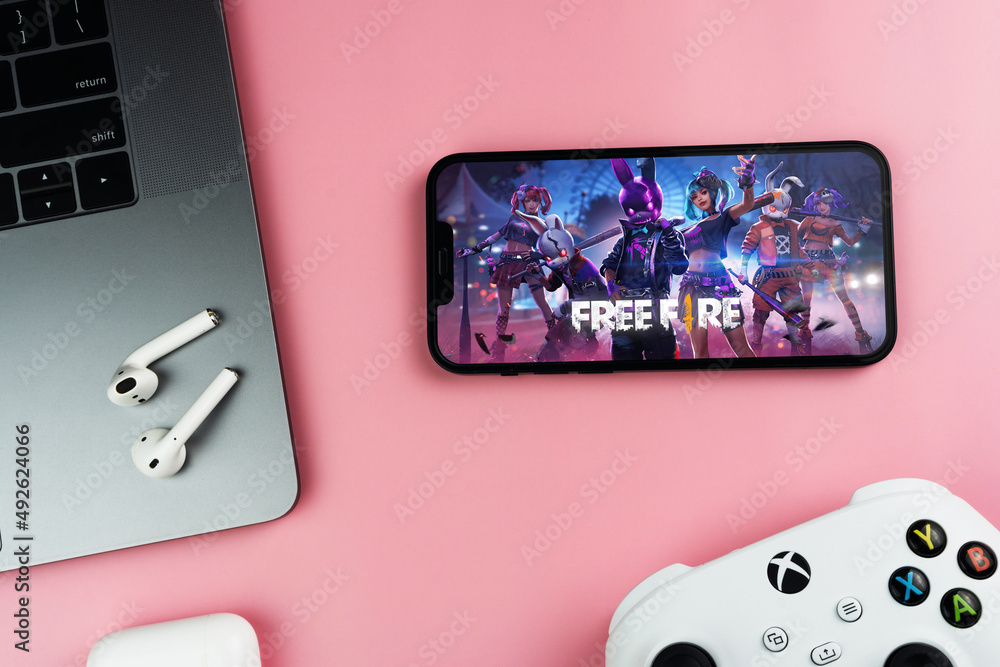 Free Fire mobile game app on the smartphone screen. Pink background ...