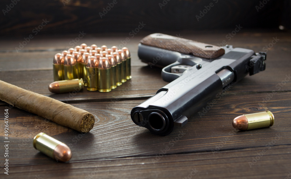 Legendary U.S. Army handgun Colt 1911A1 with .45 bullets and a cigar on ...