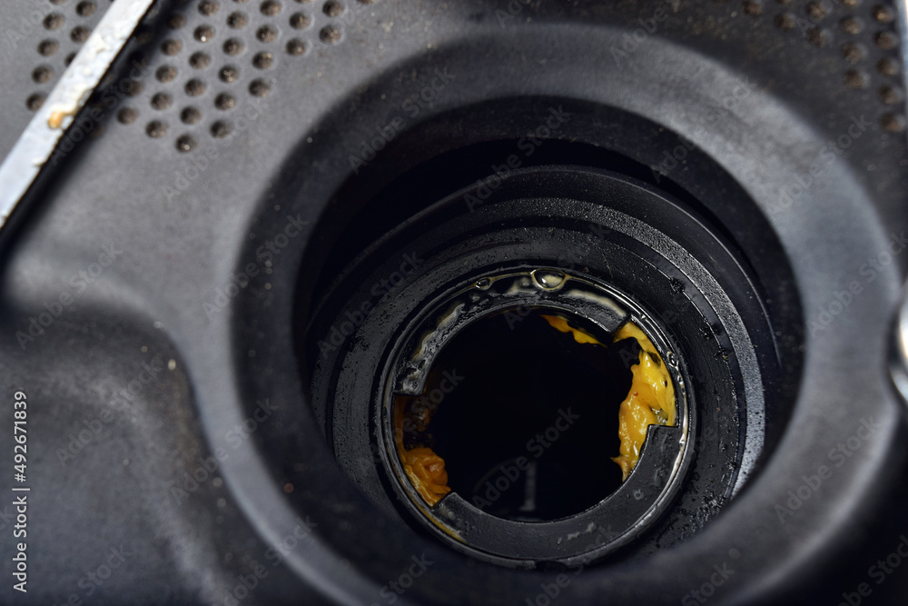 The thick, greasy yellow motor oil under oil cap as signs and symptom ...