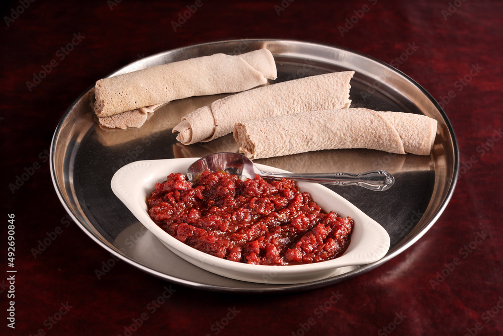 Ethiopian dish of Kitfo, raw minced beef marinated in mitmita and niter ...