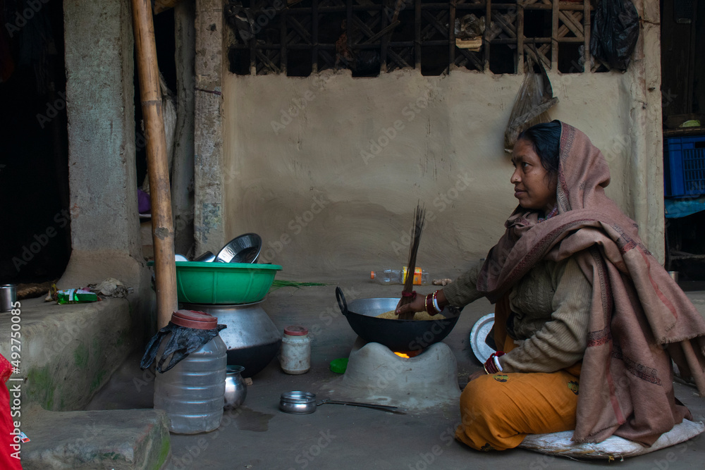 Rural Indian Woman cooking food in the Kitchen using firewood stove ...