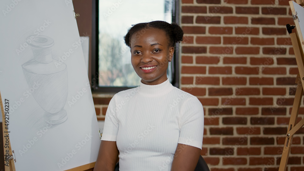 Portrait of african american woman learning to draw vase design on ...