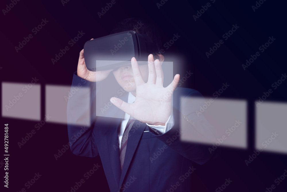 Man wearing VR Headset touching on a touch screen interface on neon ...