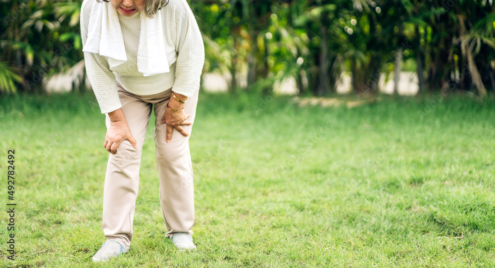Sick unhappy senior adult elderly asian woman touching her muscle ...