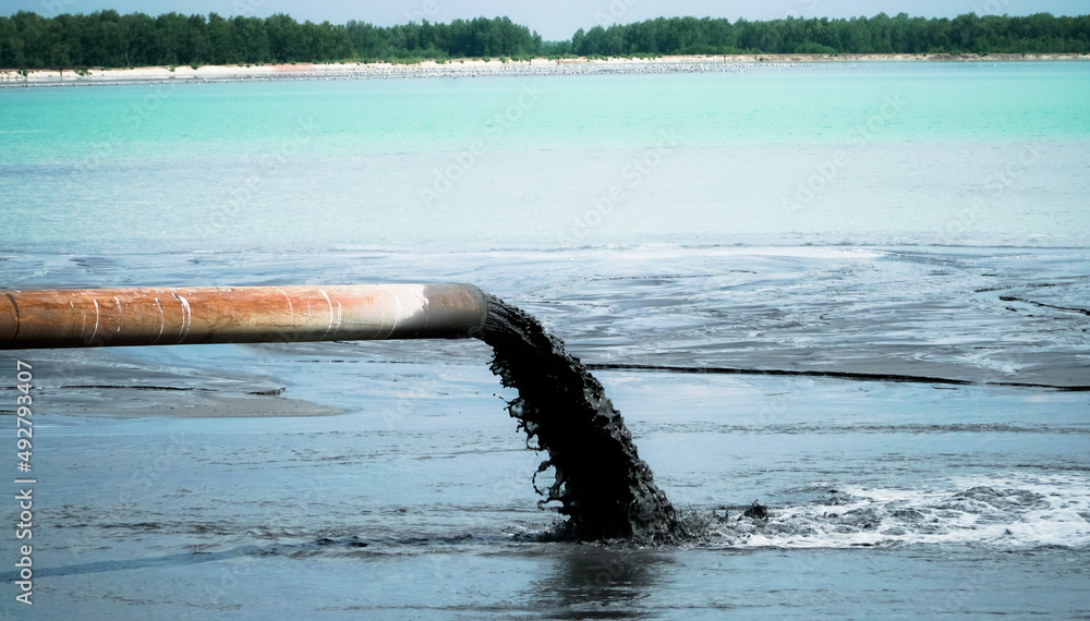 Water pollution. Dirty sewage runs from the pipe of the thermal power ...