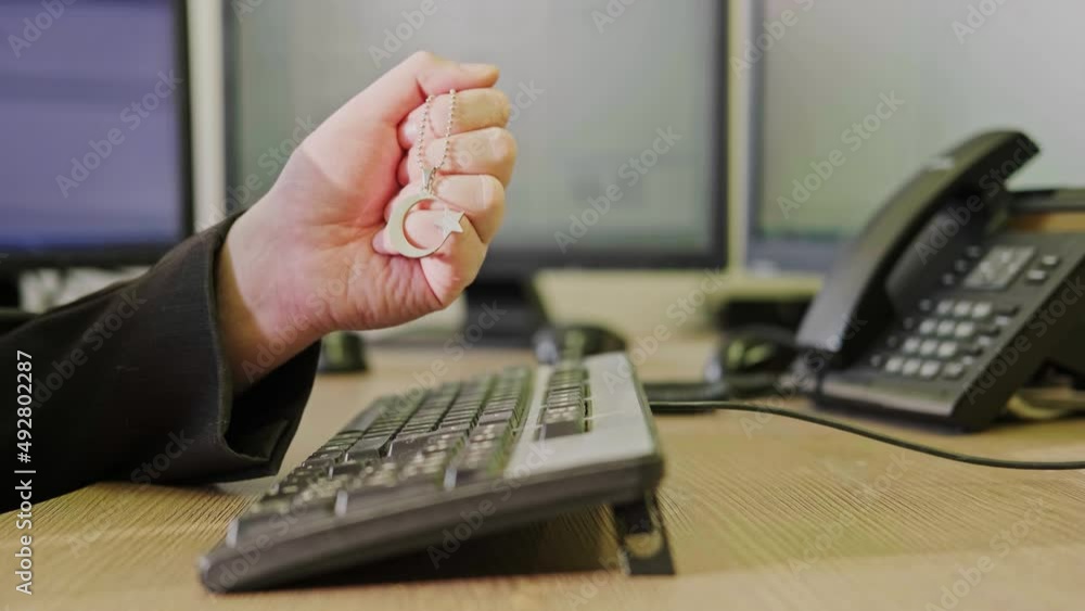 A businessman man with a religious Muslim symbol in his hands is ...