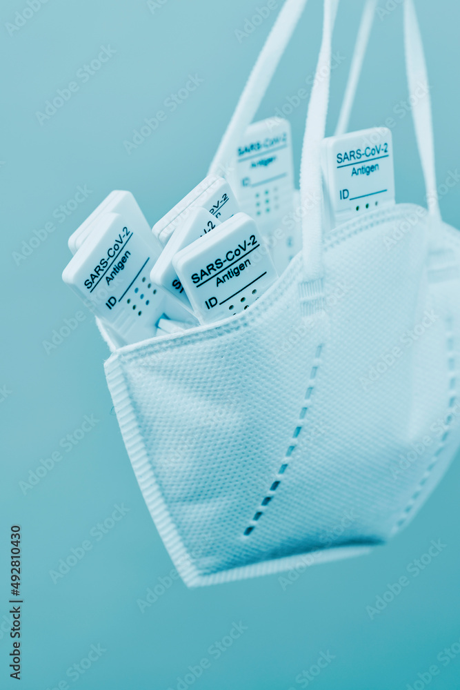 covid-19 antigen test devices in a FFP2 face mask Stock Photo | Adobe Stock