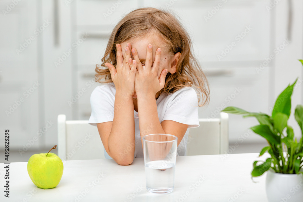 The little girl does not want or refuses to drink water. Stock Photo ...