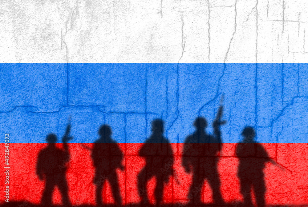 Flag of Russia painted on a concrete wall with soldiers shadows. Crisis ...