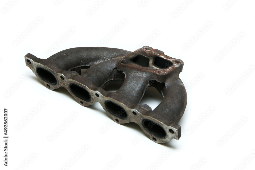 The used and rusty cast iron car engine air intake manifold isolated in ...