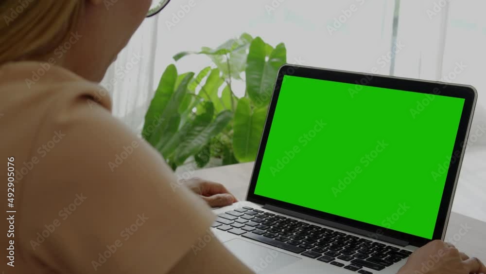 Over the shoulder shot of a business woman working in office interior ...