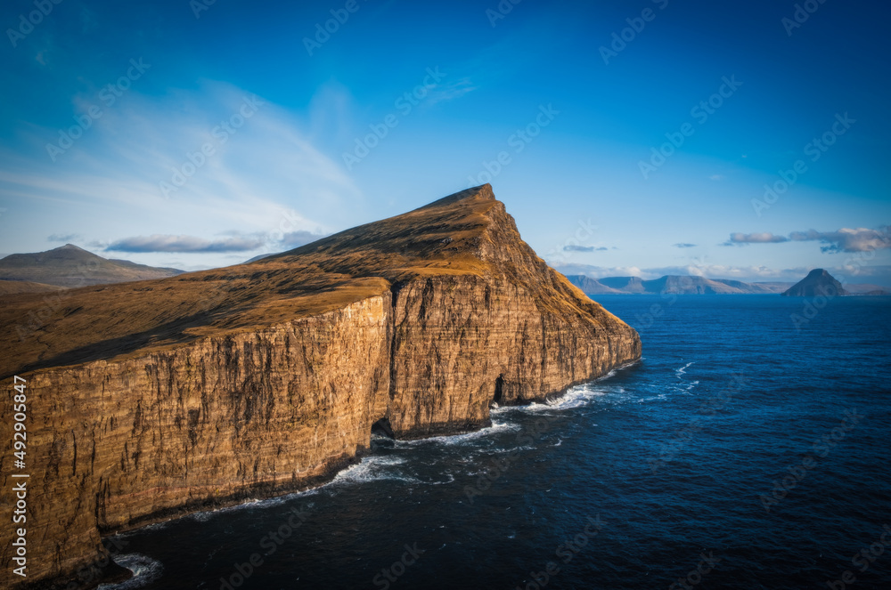 Faroe Islands Traelanipa the slaves rock cliff is seen rising over the ...