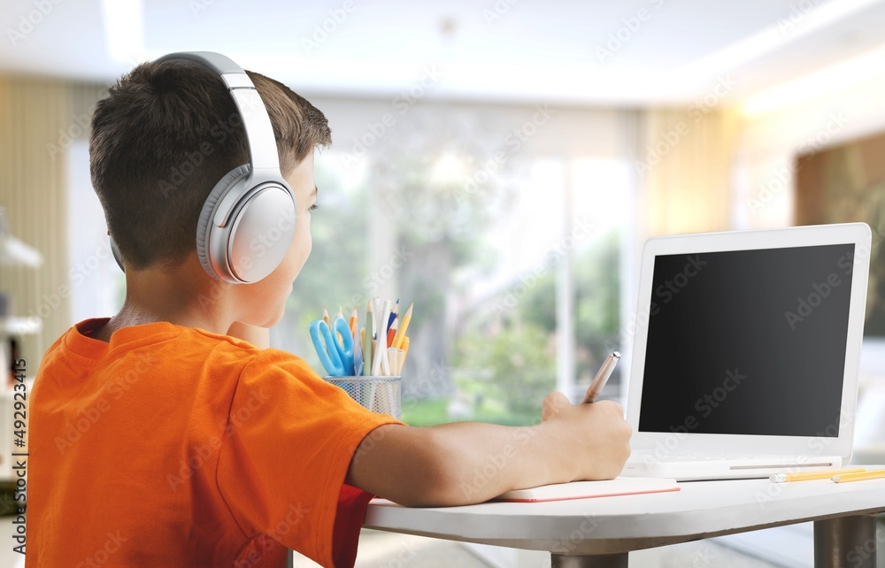 School child learning at Home. Headset study from home look. School age ... School child learning at Home. Headset study from home look. School age ...