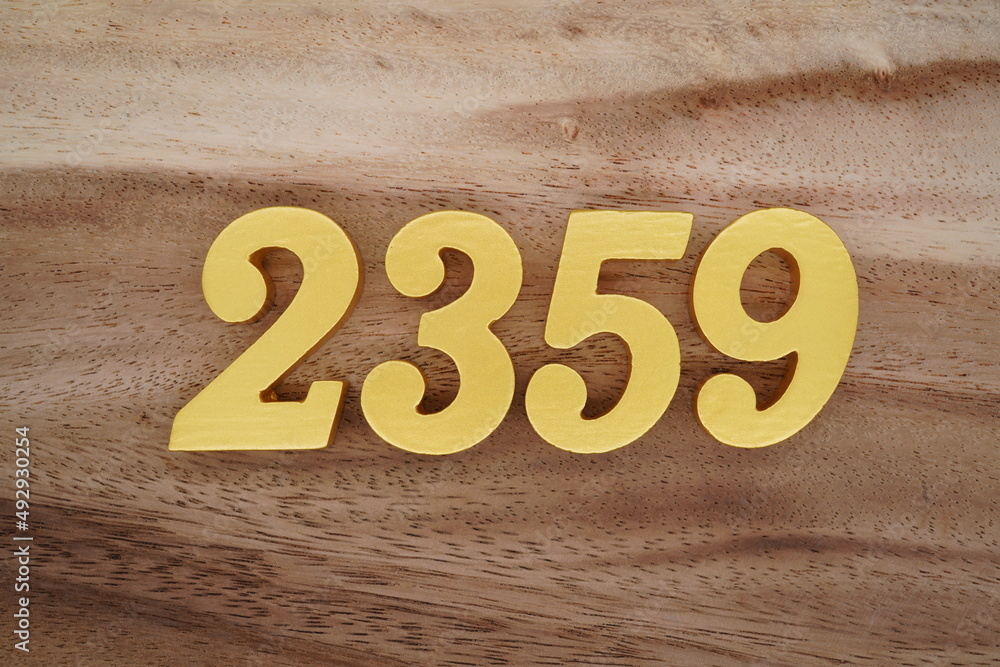 Golden Arabic numerals on a real brown and white wooden floor number ...