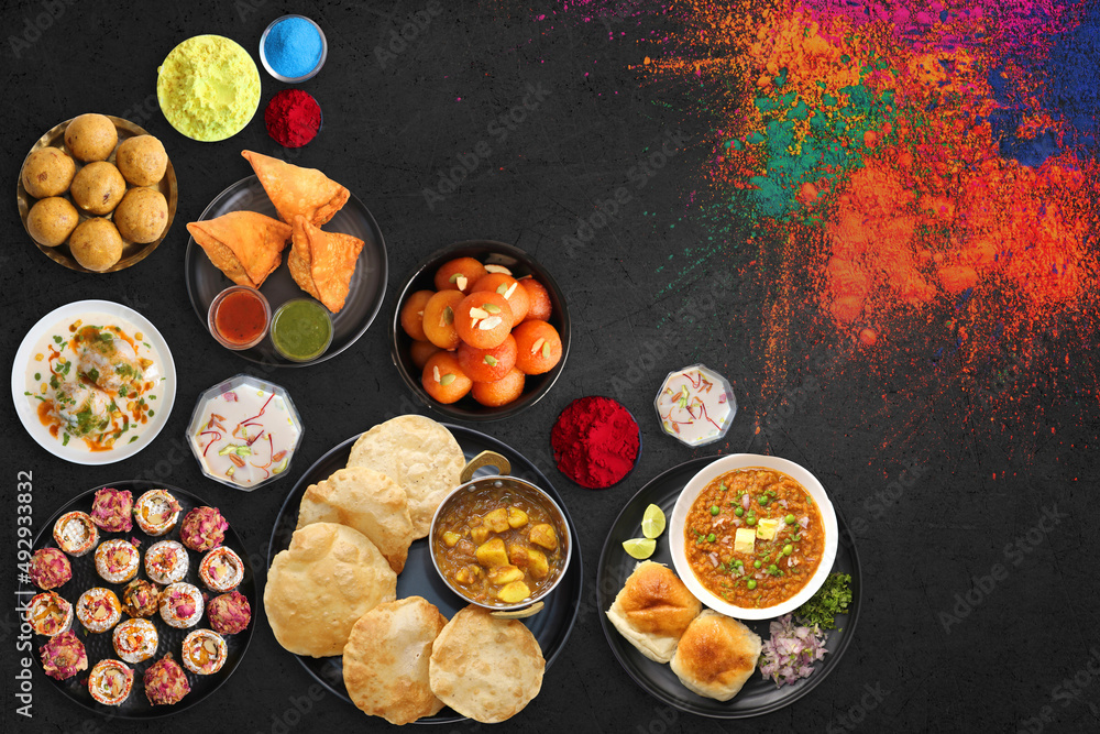 Assorted Indian Holi festival food like samosa, kachori, Puri bhaji ...