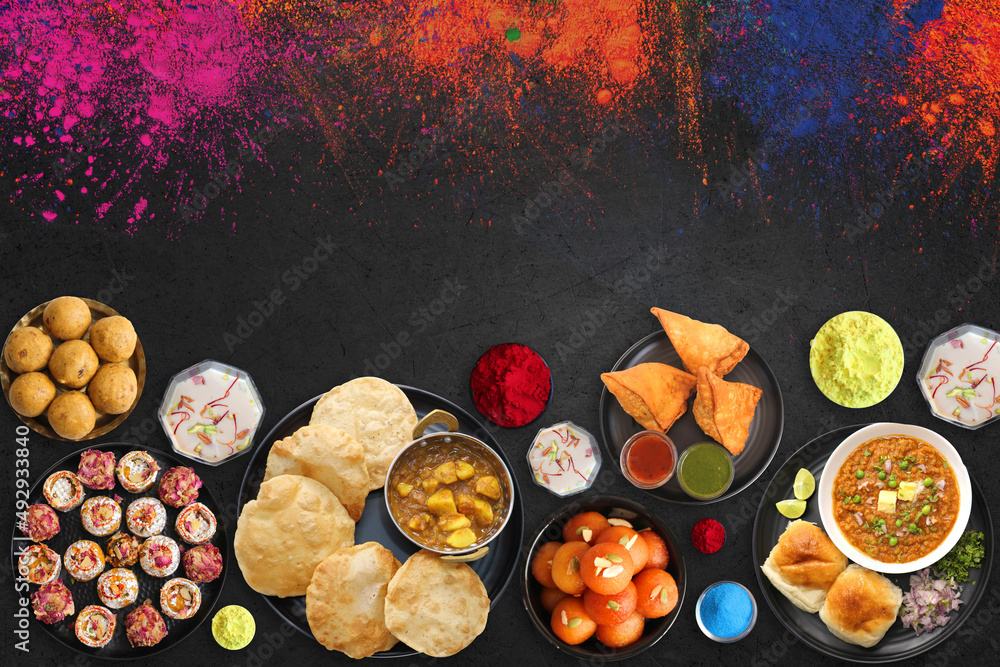 Assorted Indian Holi festival food like samosa, kachori, Puri bhaji ...