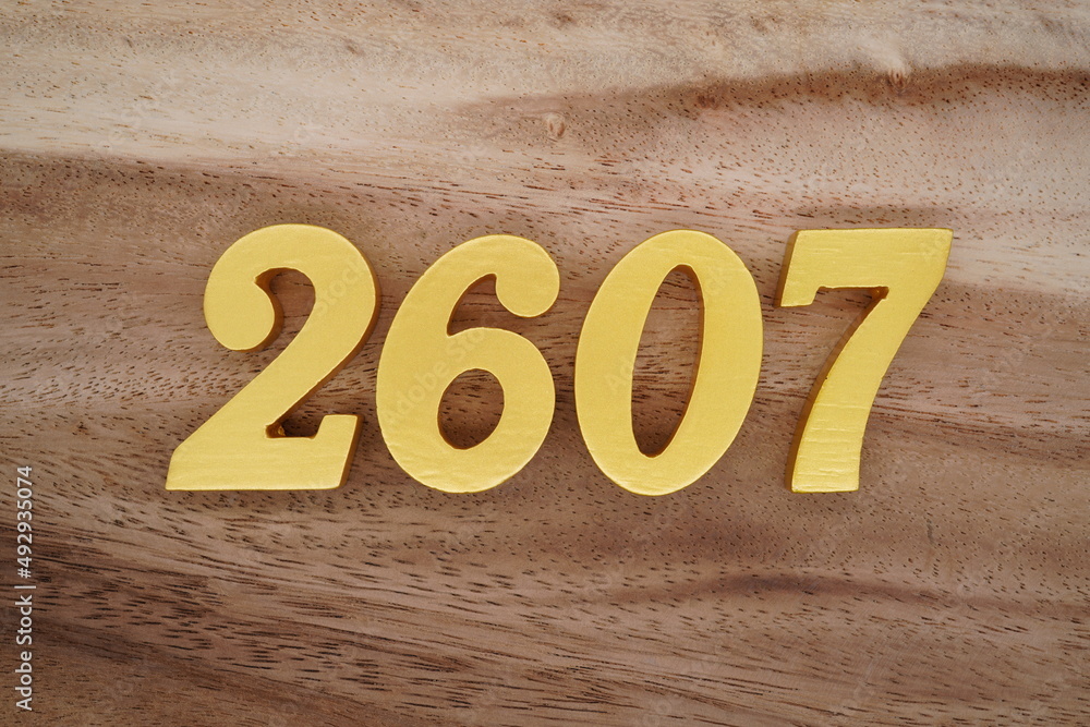 Golden Arabic numerals on a real brown and white wooden floor number ...