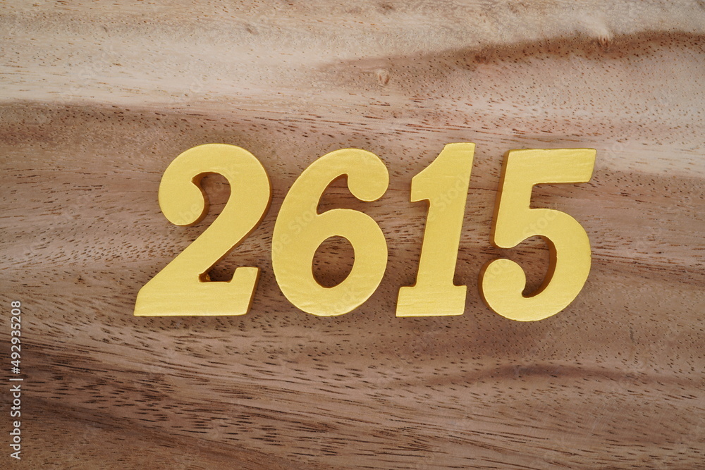 Golden Arabic numerals on a real brown and white wooden floor number ...