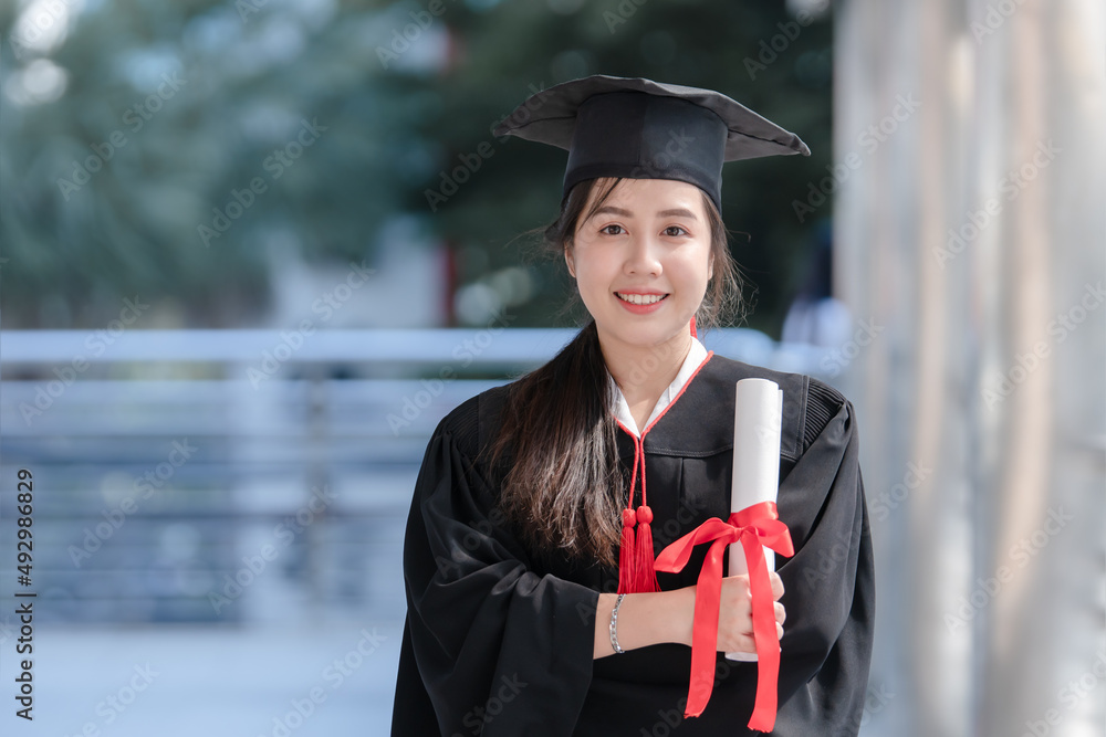 Happy Asian young beautiful graduate female student with University ...